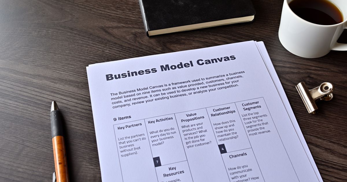 How does a business plan differ from a business model canvas?